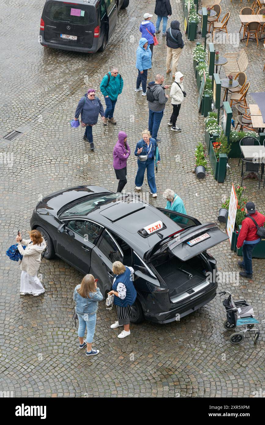 A cab arriving and passengers getting out on the market square in ...