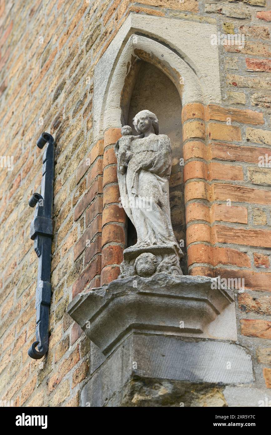 Statue of the Virgin Mary with child on a house wall in the historic ...