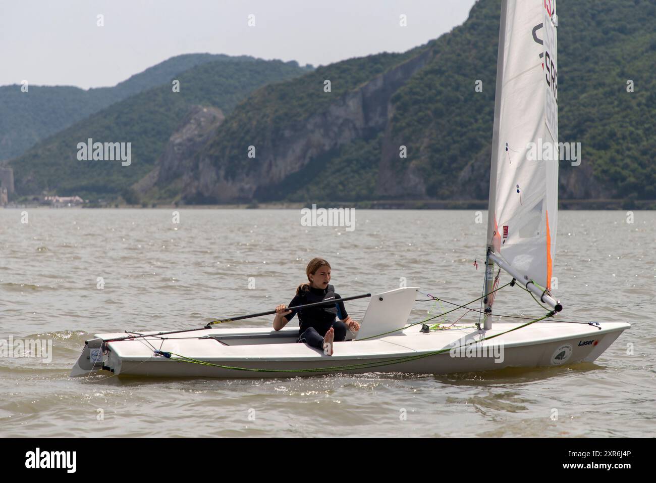 Golubac, Serbia, June 9, 2024: A teenage girl takes a break between two ...