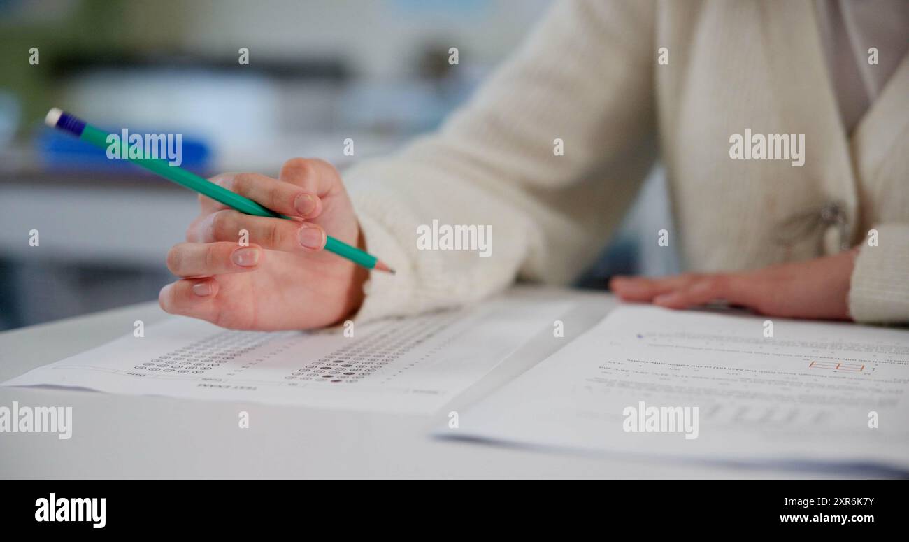 Education, exam and hands at desk with paper, test and multiple choice ...