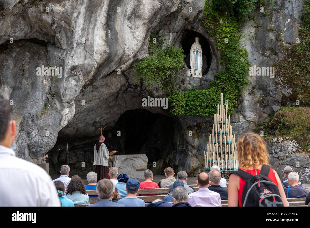 group of Christian people attend mass in the grotto of the apparition ...