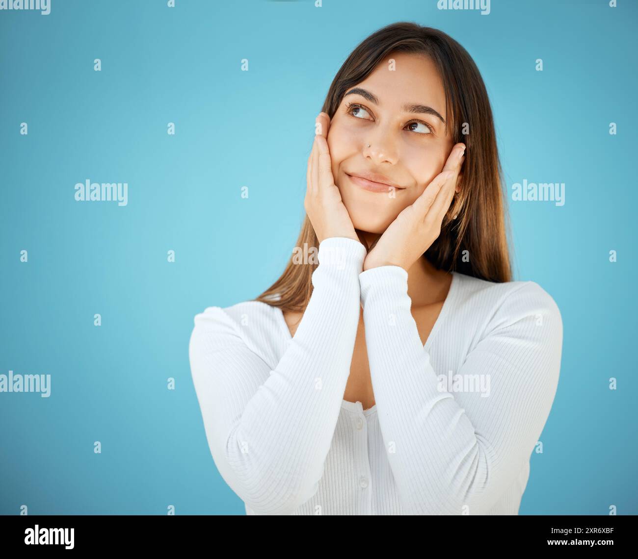 Happy, woman and thinking with shy, smile and hands to face with idea ...