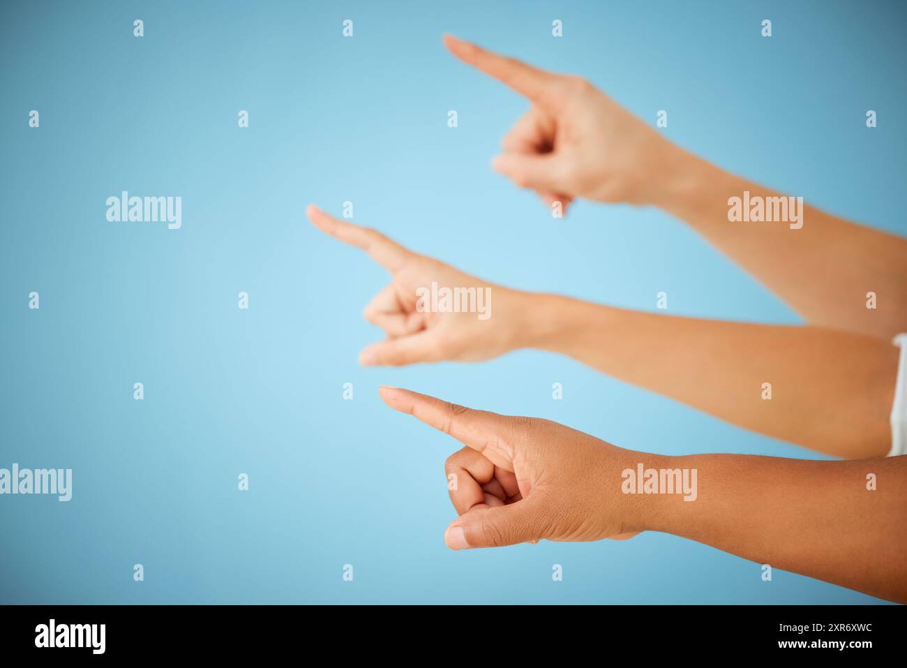 Group, pointing and hands in studio, direction and forward in space ...