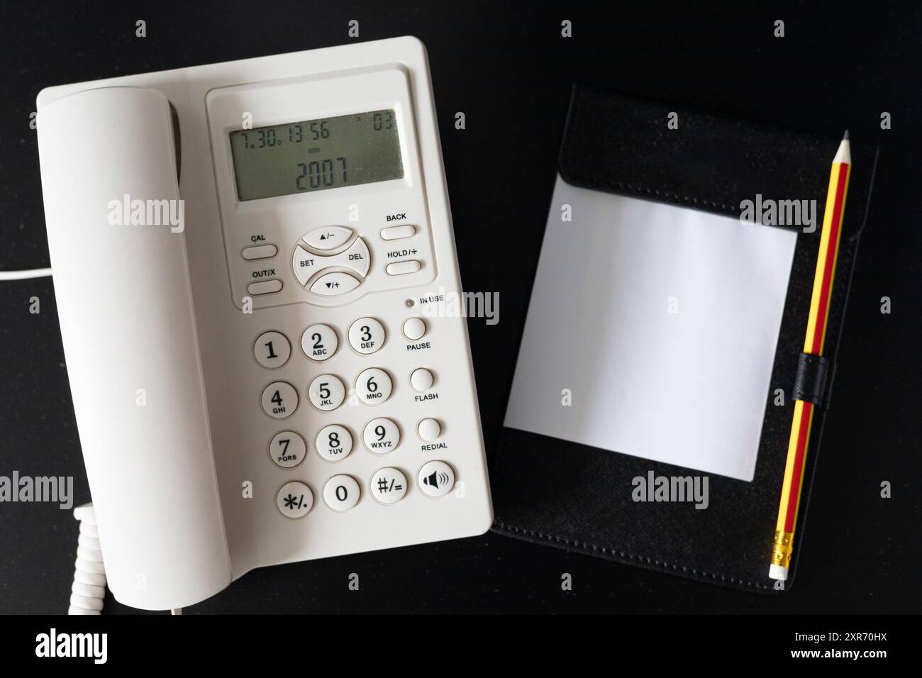 Office Desk Essentials: A Phone, Notepad, Pencil, and Keyboard on a ...