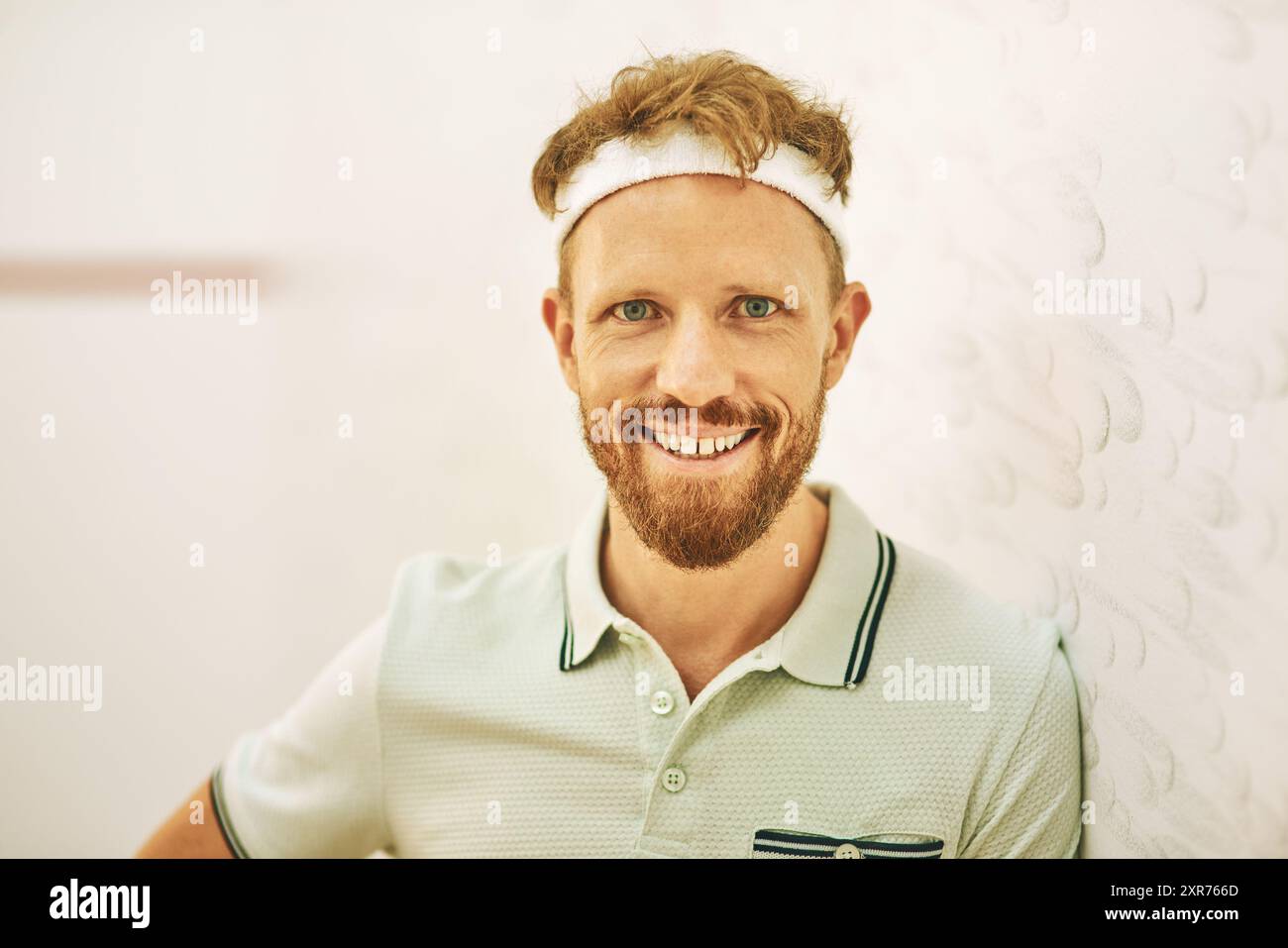 Portrait, smile and sports with squash player man on wall background in ...