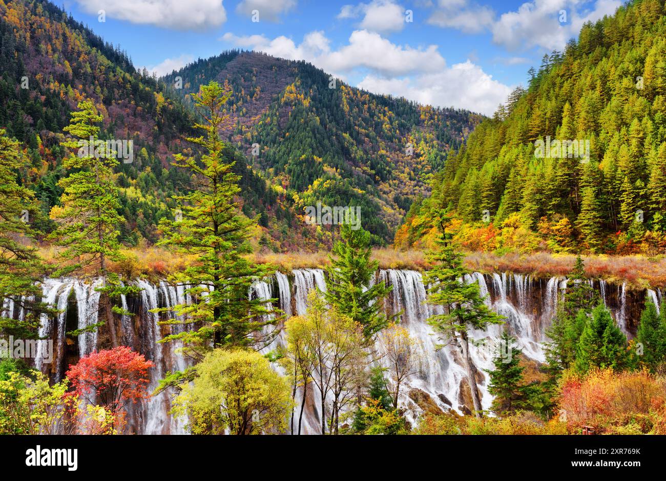The Nuo Ri Lang Waterfall (Nuorilang) among woods and mountains Stock ...