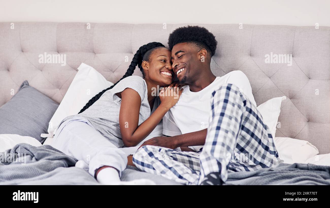 Smile, black couple and relax with care in bedroom of hotel for weekend ...