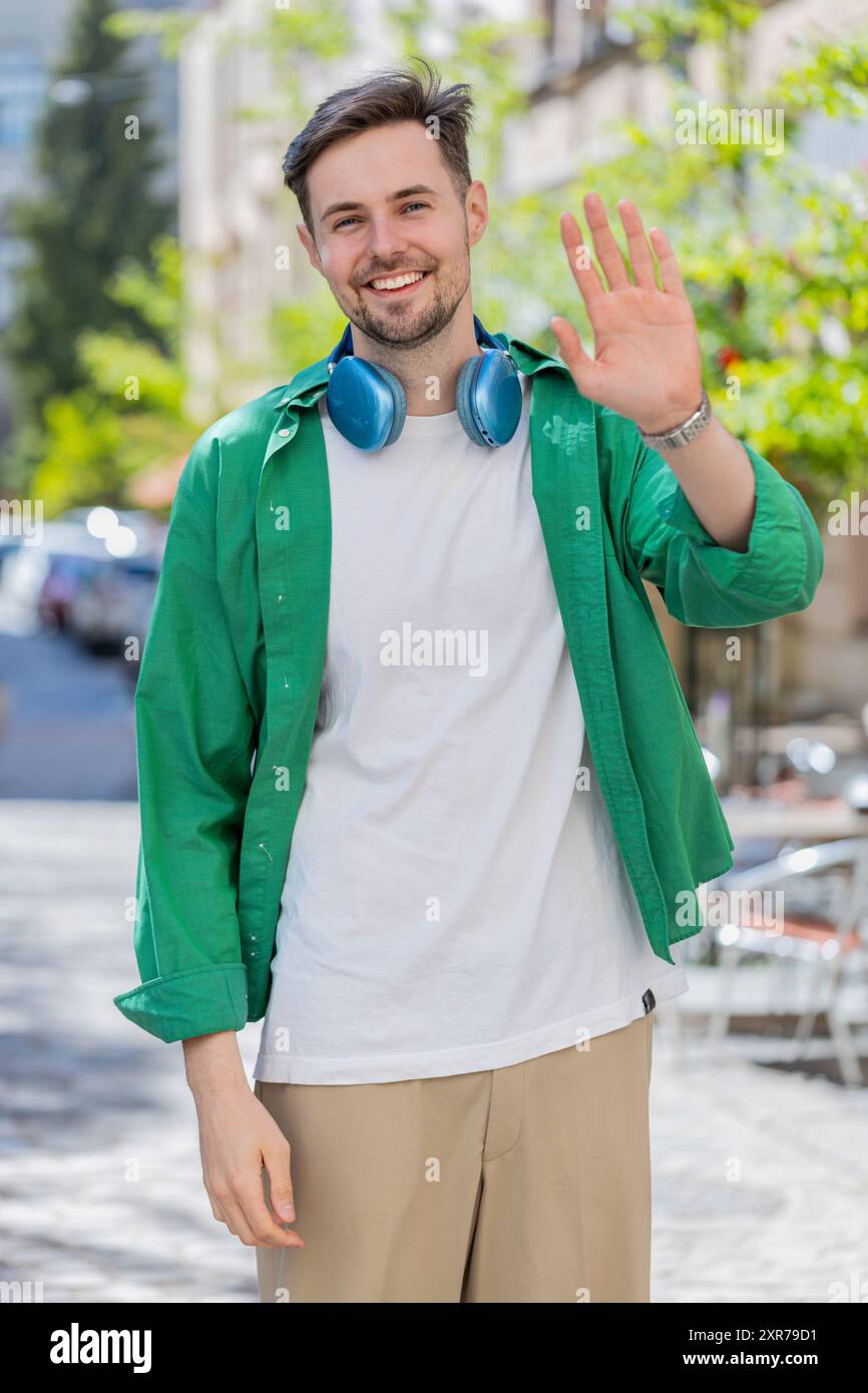 Welcoming man waving hand hello hi-res stock photography and images - Alamy