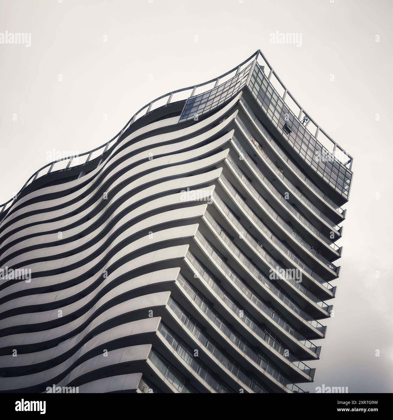 Modern multistory building with wavy exterior. Wave like building view ...