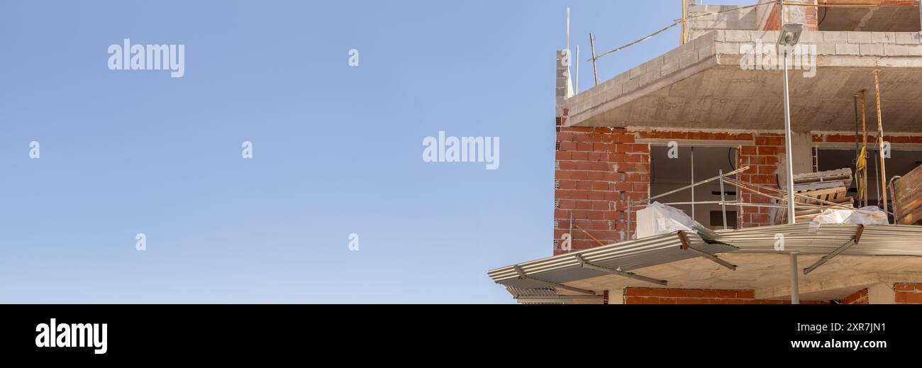 Bustling construction site, featuring an unfinished building with ...