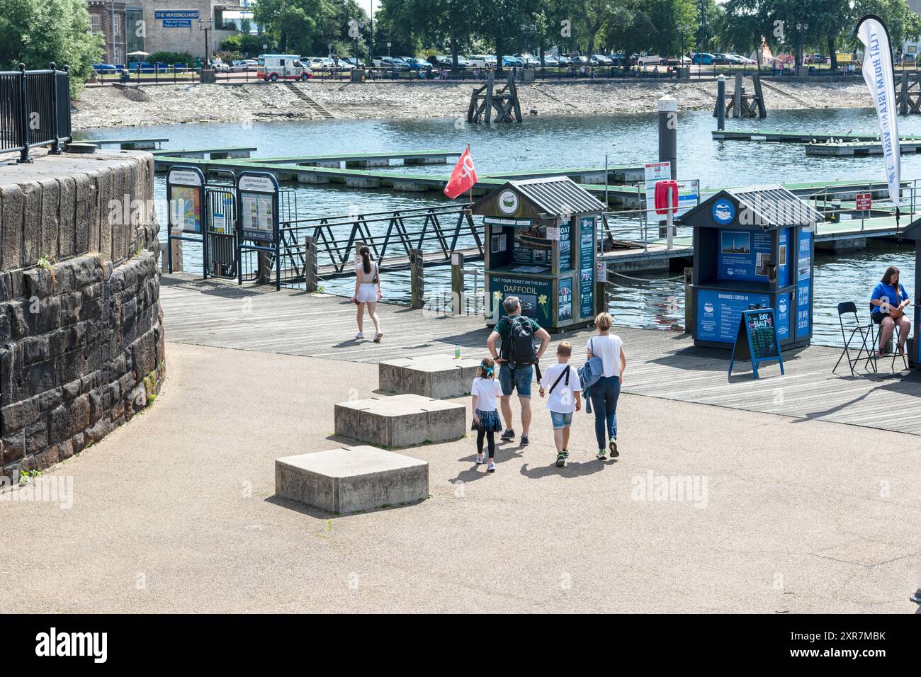 A family walking on the wharf on their visit to Cardiff Bay, Cardiff UK ...