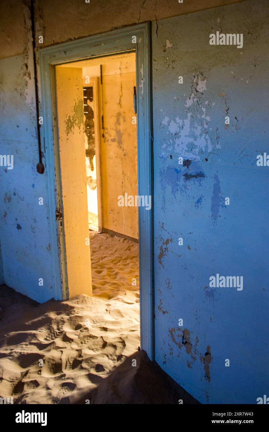 Bright sunlight shining through a doorway into one of the sand filled ...