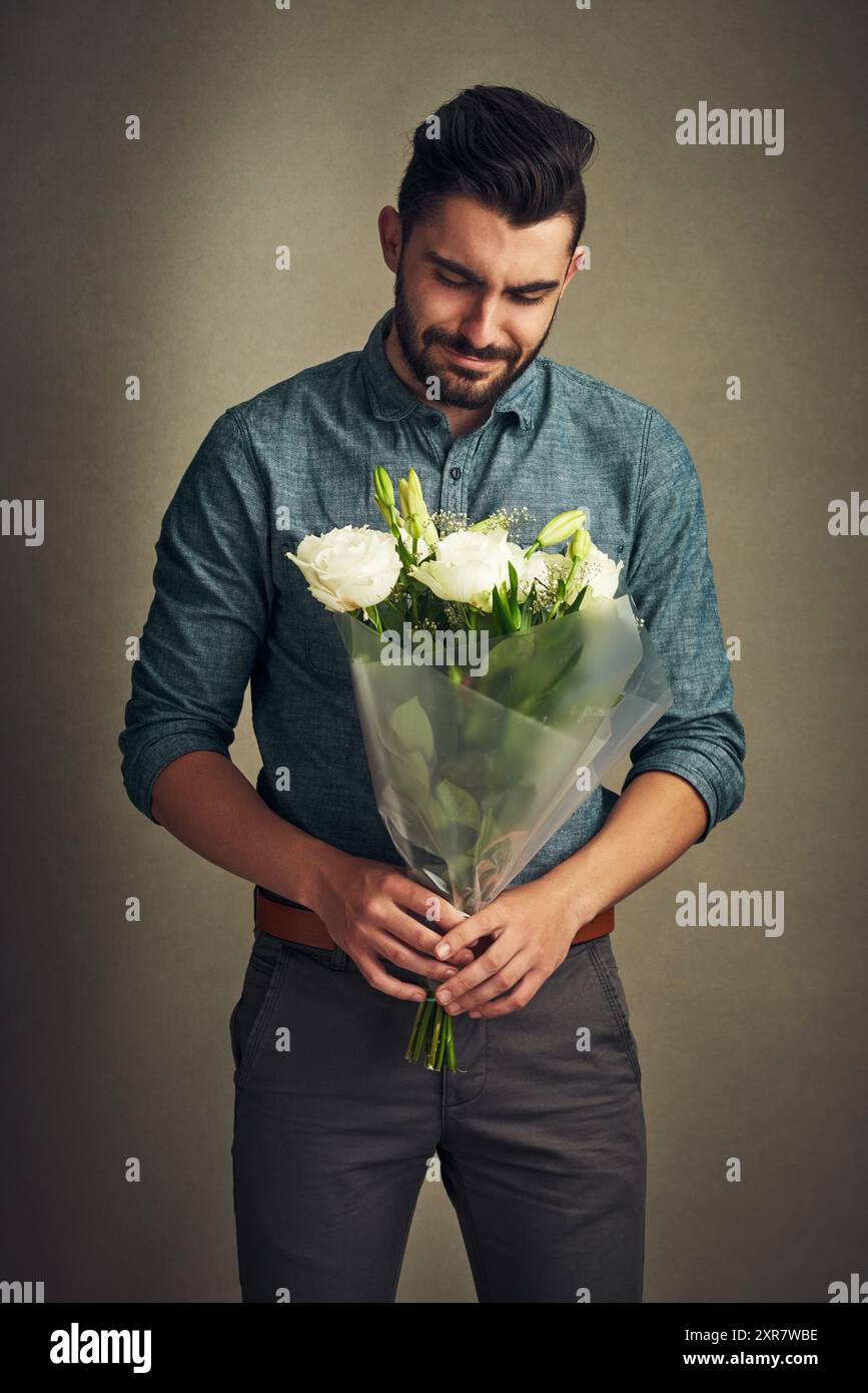 Sad man holding bunch flowers hi-res stock photography and images - Alamy
