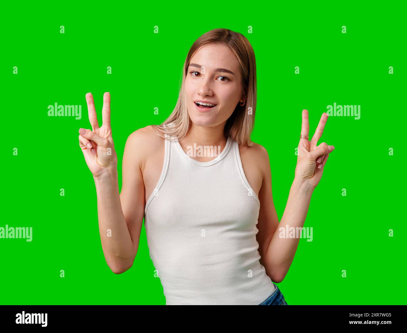 Young Woman Making Peace Sign With Both Hands Against Green Screen ...