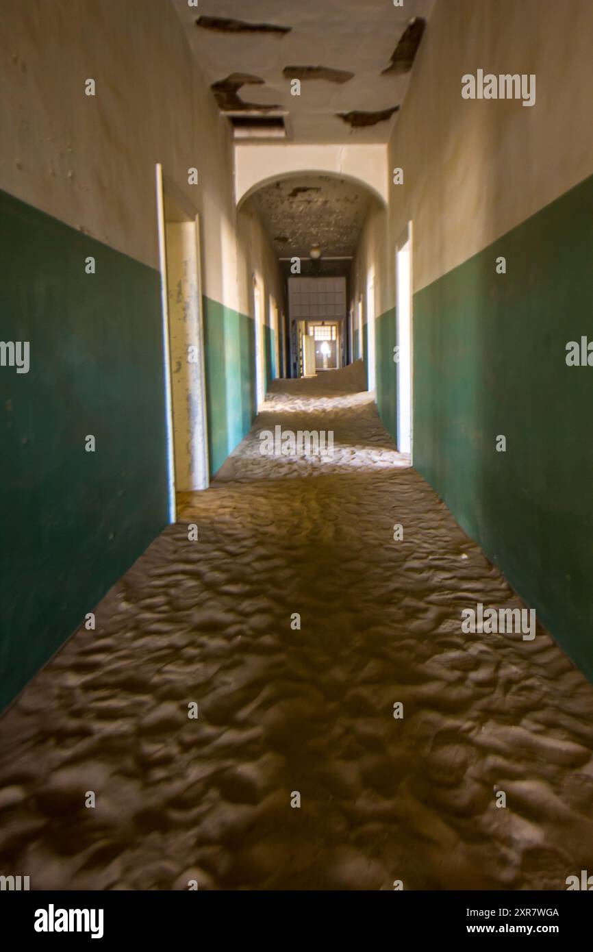 The eery sand filled hallway of the hospital of the abandoned mining ...