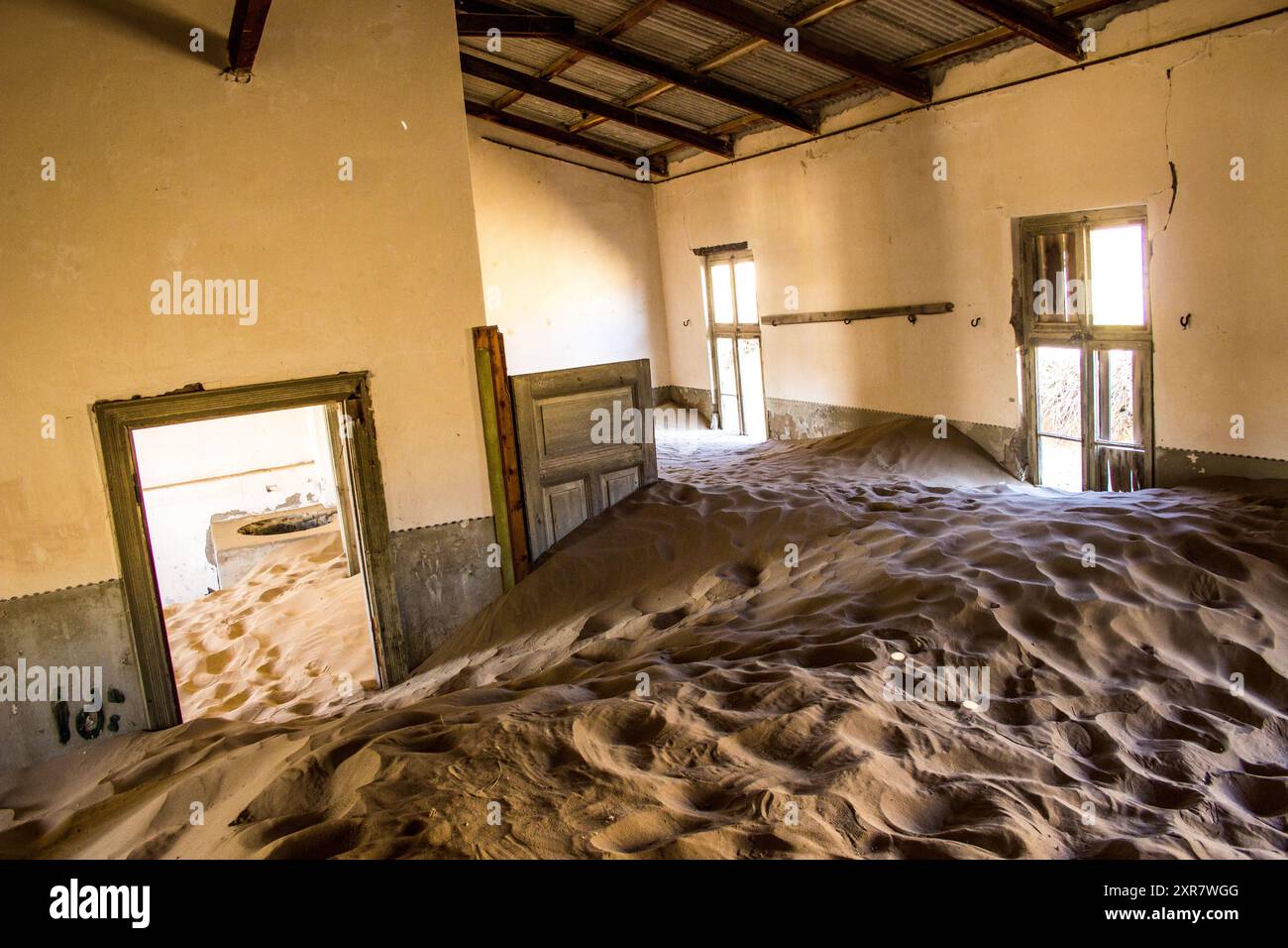 Inside an abandoned building, half buried in sand in the Namibian ghost ...