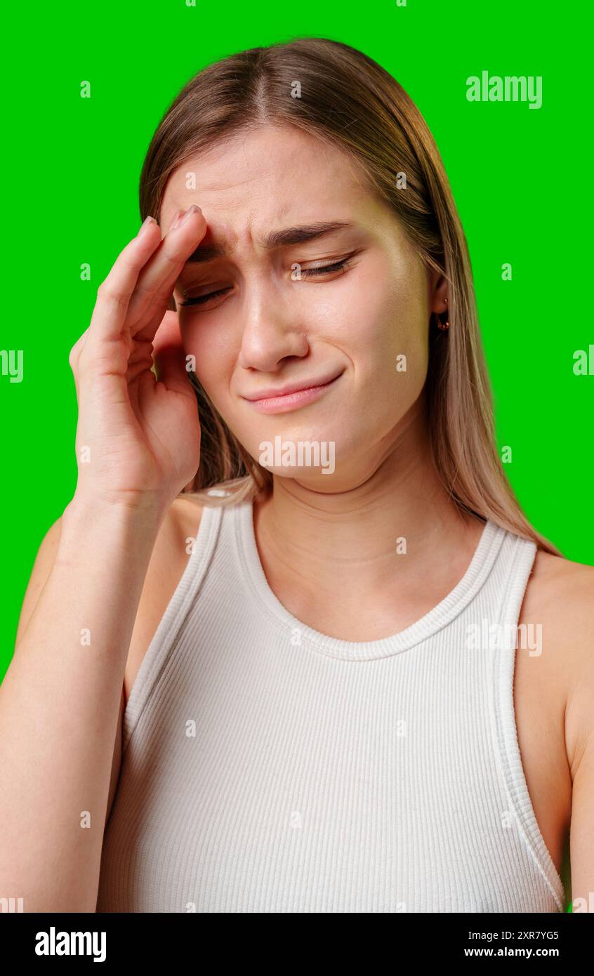 Young Woman Holding Forehead and Crying In Front of Green Screen Stock ...