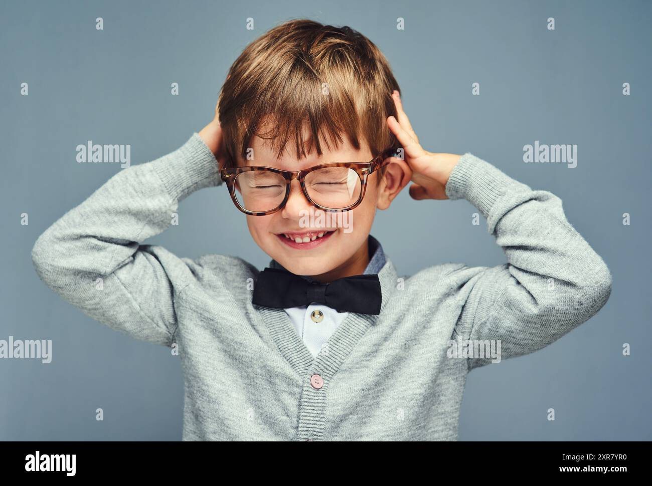 Fashion, bow tie and kid in studio with glasses for thinking, problem ...