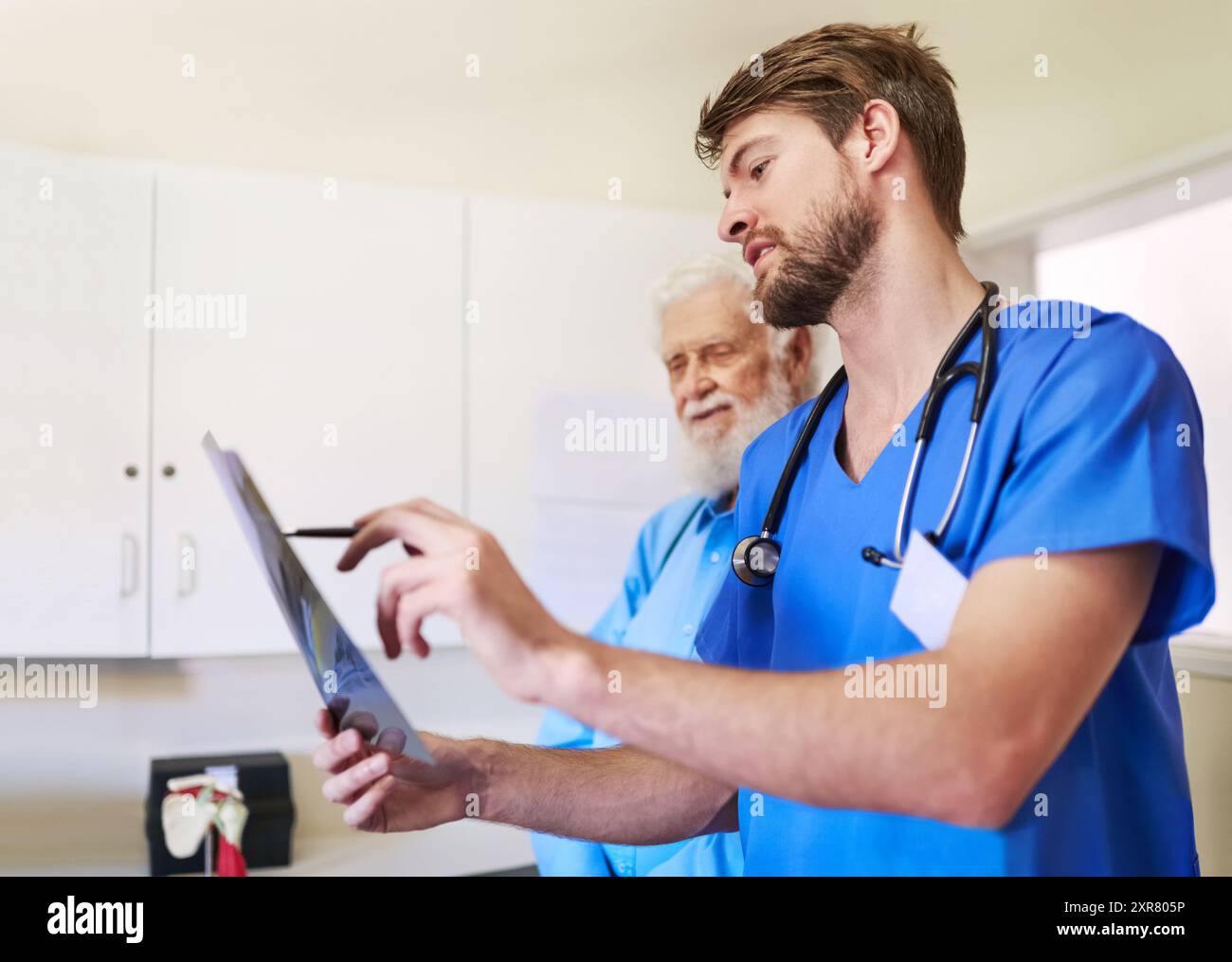 Hospital, meeting and nurse with xray by man for diagnosis, evaluation ...