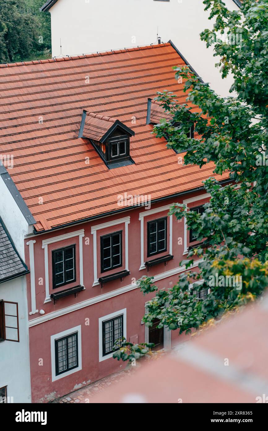 A charming historic building features a striking red rooftop and ...