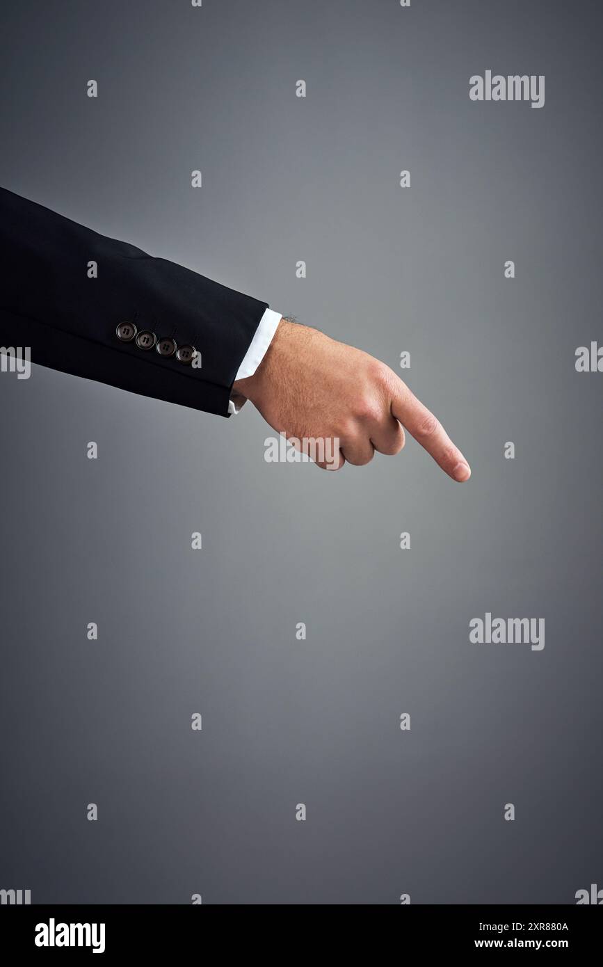 Pointing, finger and business person in studio, assertive and authority ...