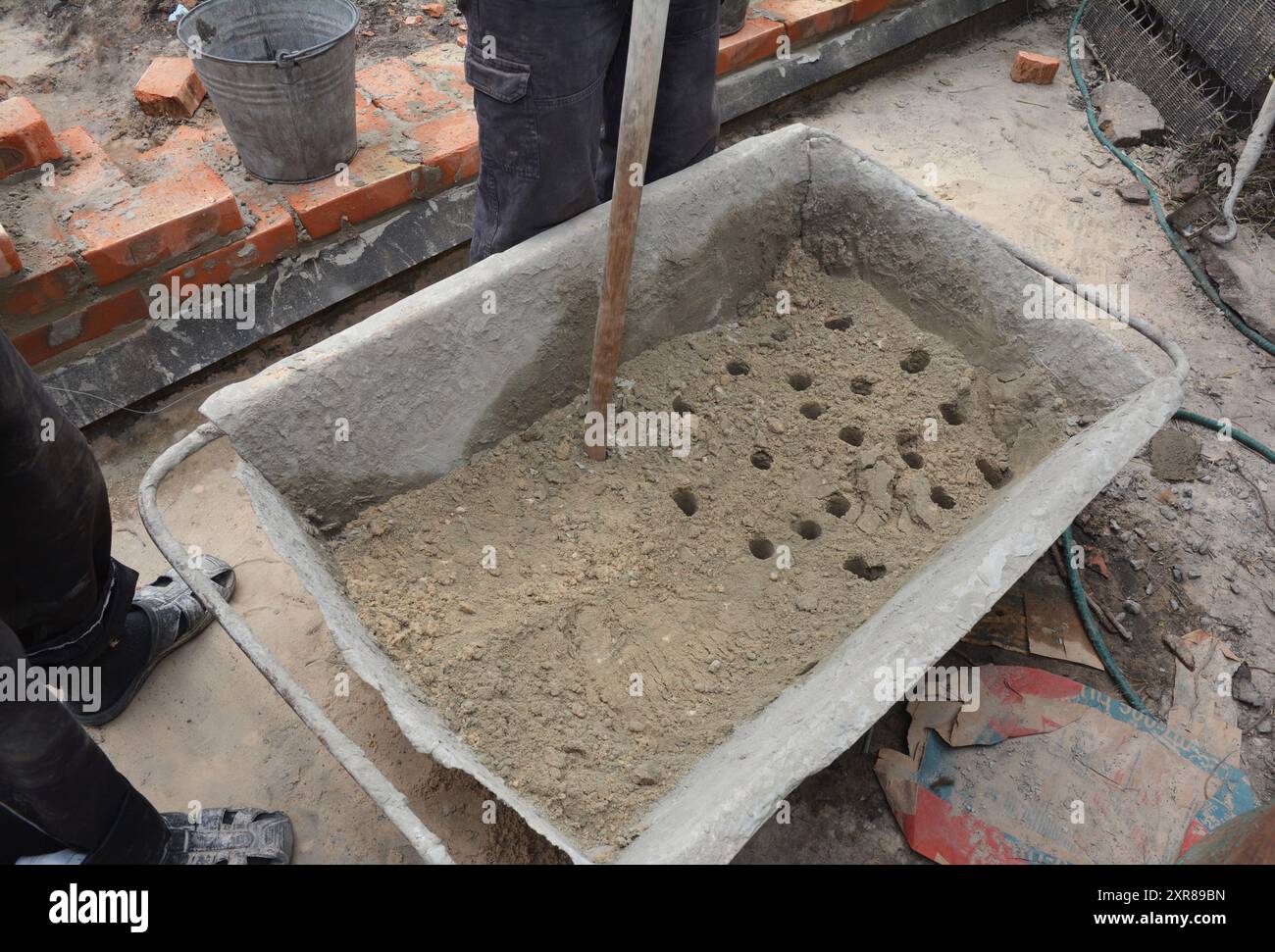 Builders making construction concrete mixing sand and cement Stock ...