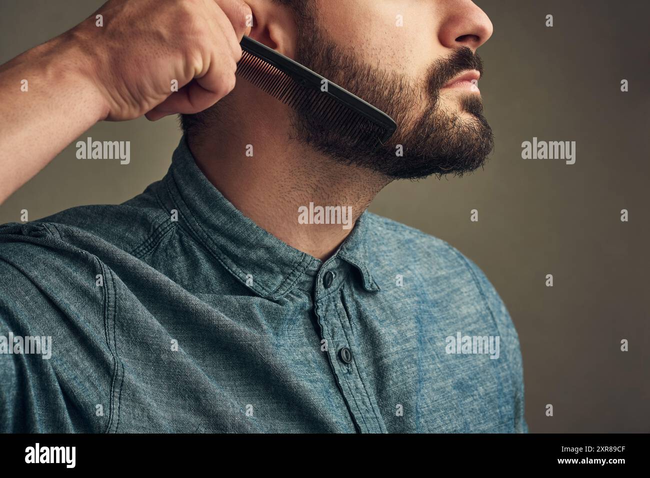 Man, cleaning and comb beard on studio background for facial hair ...