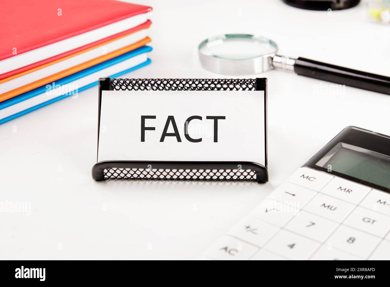 FACT CONCEPT. FACT on a business card in a stand on a white background ...