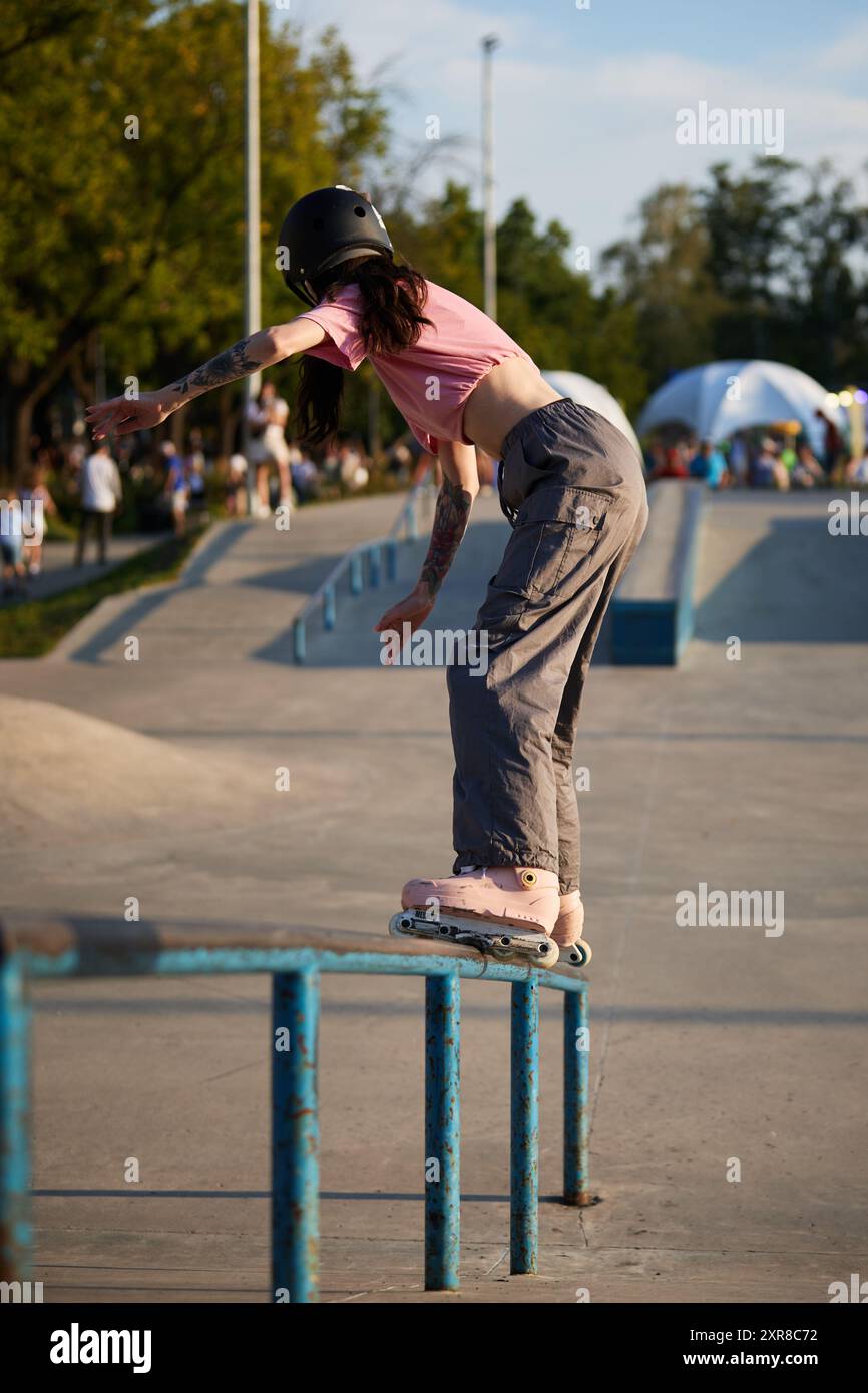Young girl grinding on a handrail in skatepark. FS royale trick. Kyiv ...