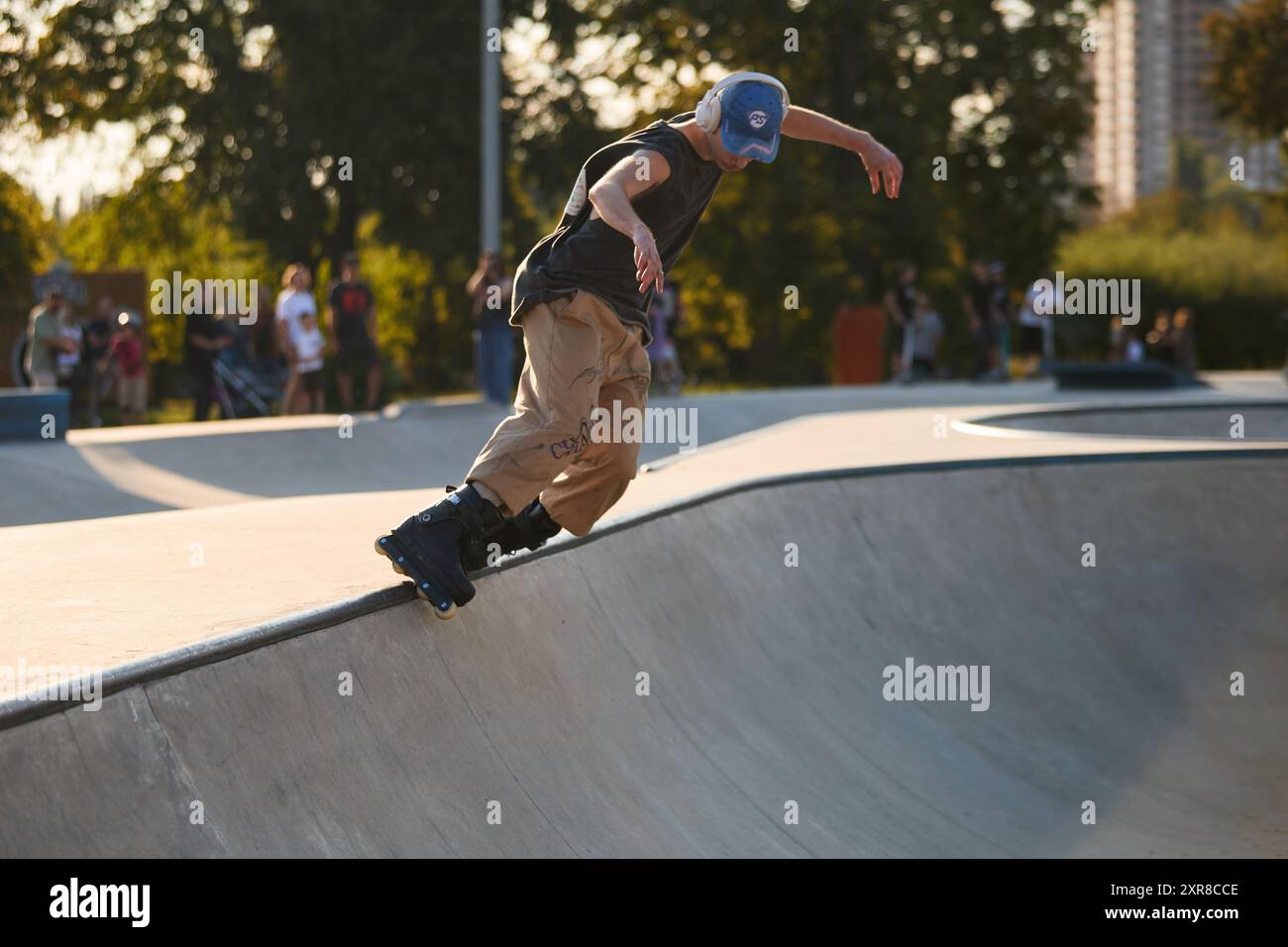 In-line skater grinding in a concrete pool during skate contest. Kyiv ...