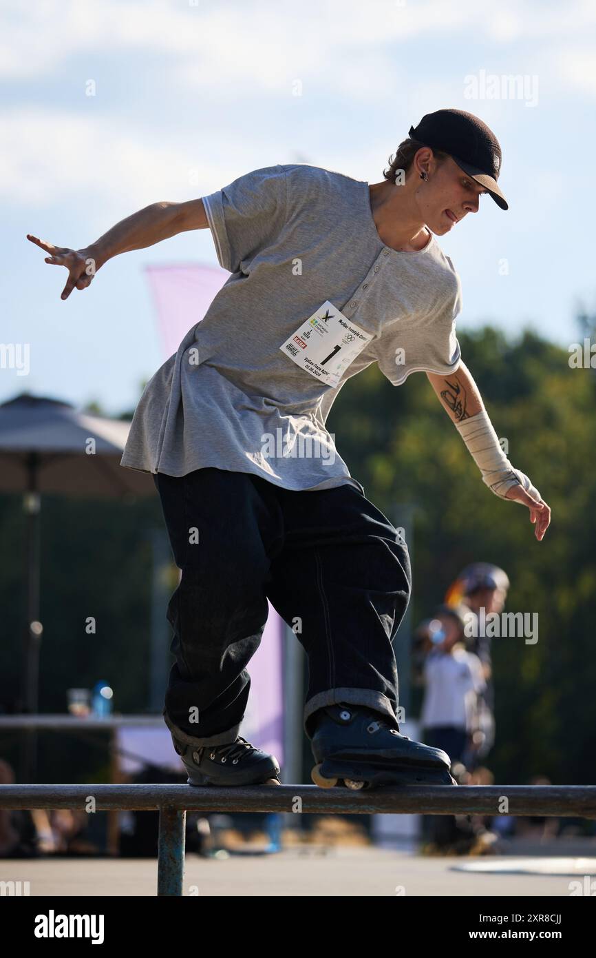 Roller blader performing acid soul grind on a rail in skate park. Kyiv ...