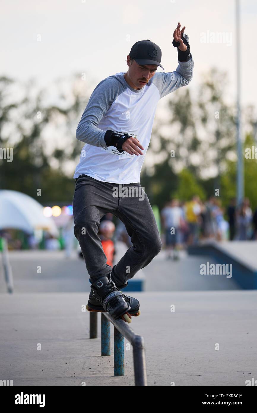In-line skater doing miszou grind on rail in skatepark. Kyiv - 4 August ...