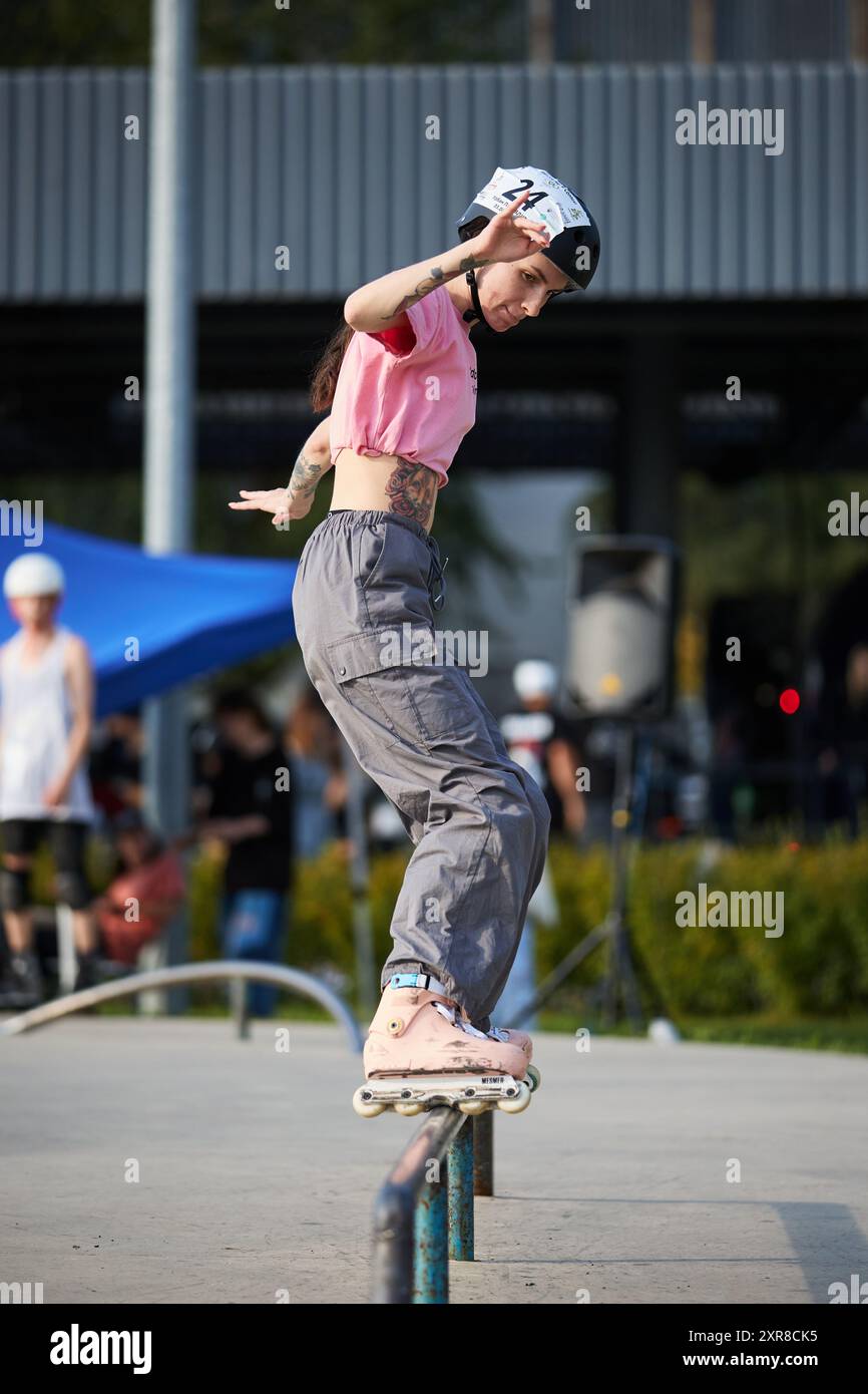 Roller girl grinding on a rail. Fs royale trick. Kyiv - 4 August,2024 ...