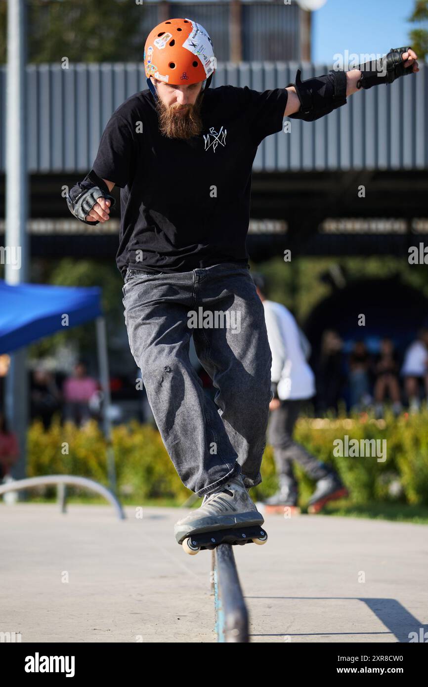 Aggressive inline skater doing acid grind on a rail. Kyiv - 4 August ...