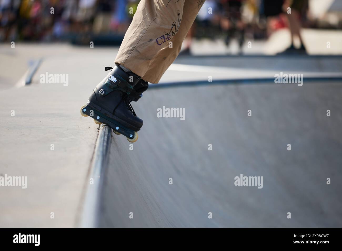 Aggressive inline skating in a skate pool. Roller blader grinding on a ...