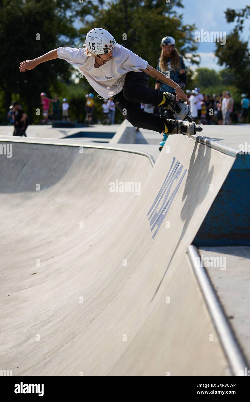 In-line roller performing fishbrain grind in a skate pool. Kyiv - 4 ...