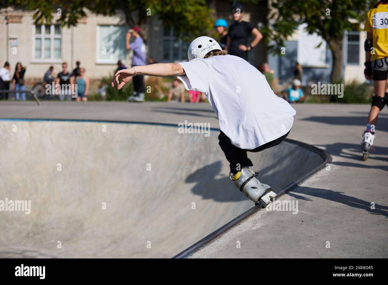 Aggressive inline skating. Roller skater doing fish brain grind on ...