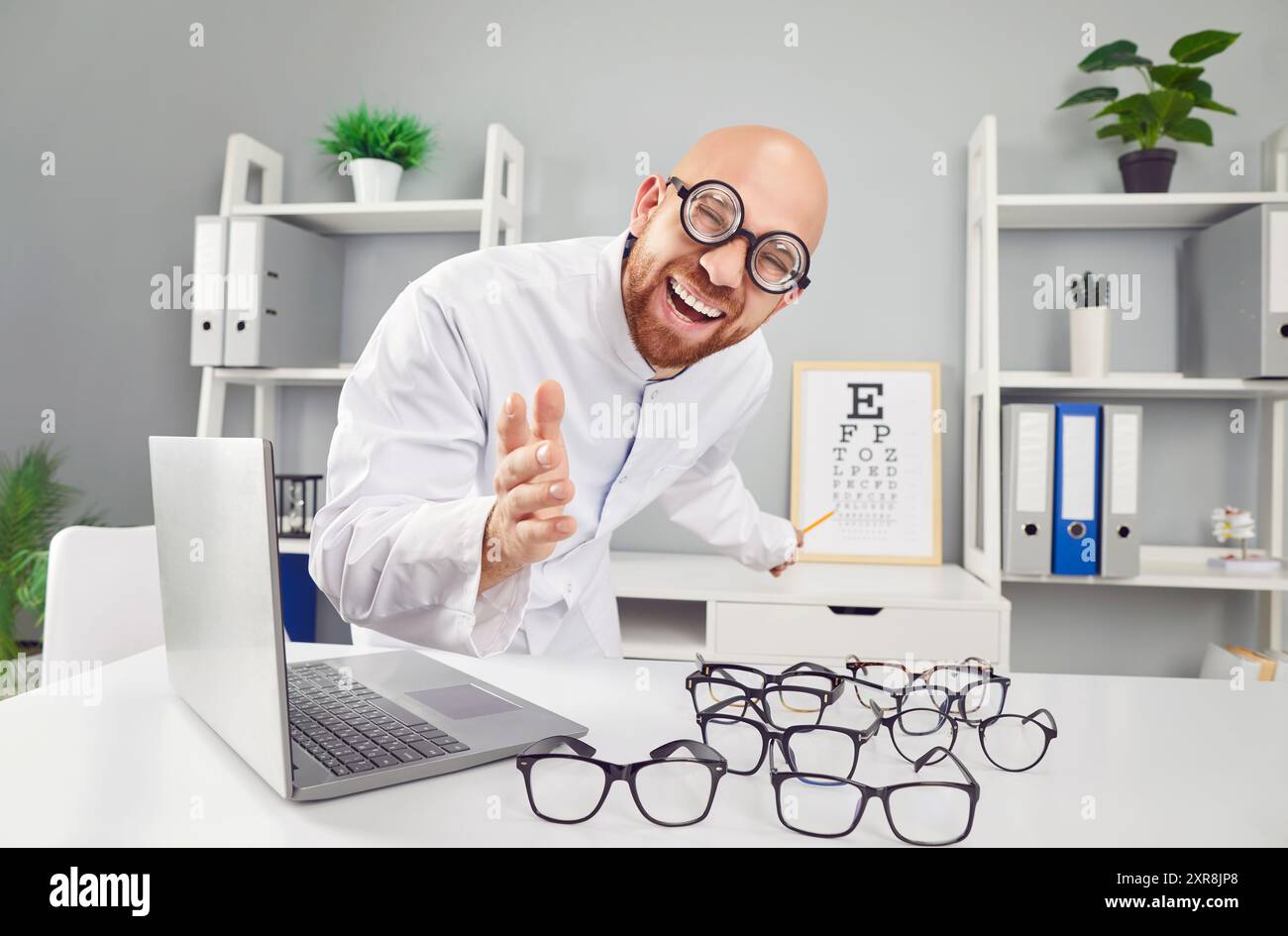 Ophthalmologist, funny smiling doctor showing eye chart, smiling in ...