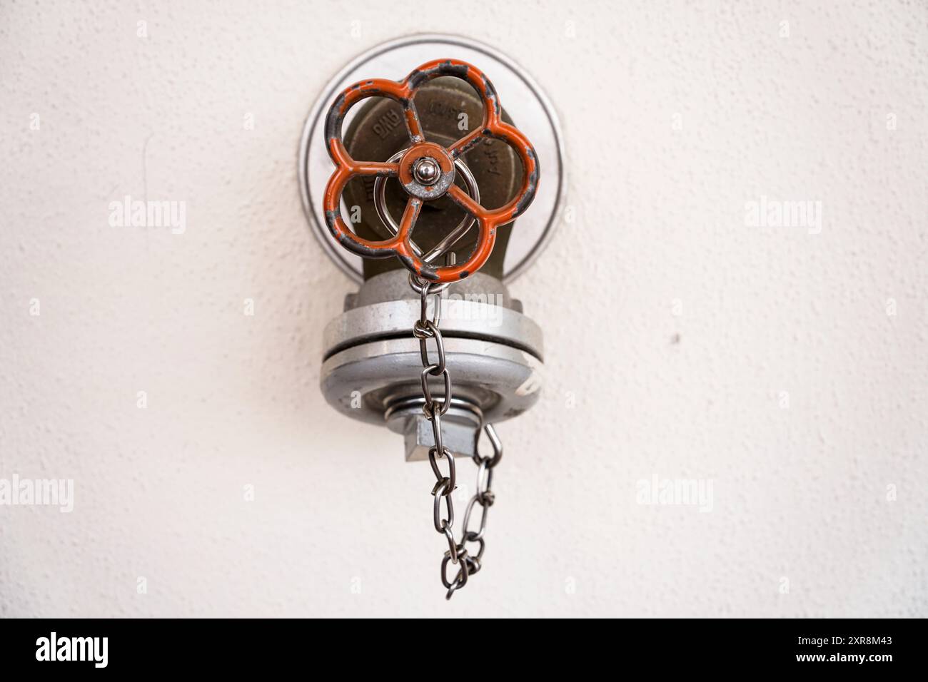 Water hydrant on a building wall Stock Photo - Alamy