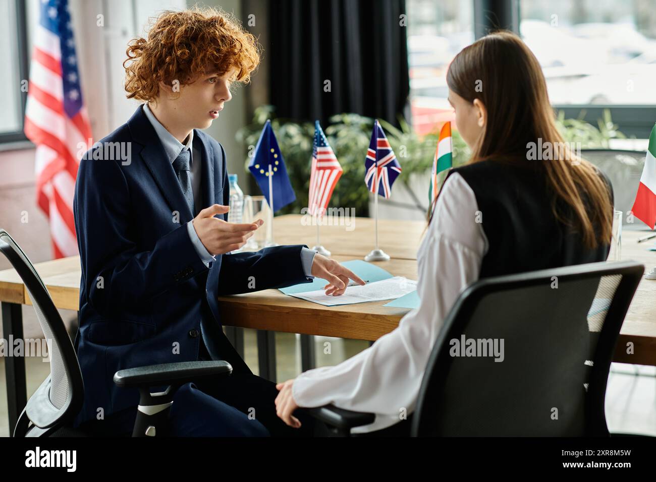 Two teenagers participate in a Model United Nations simulation ...