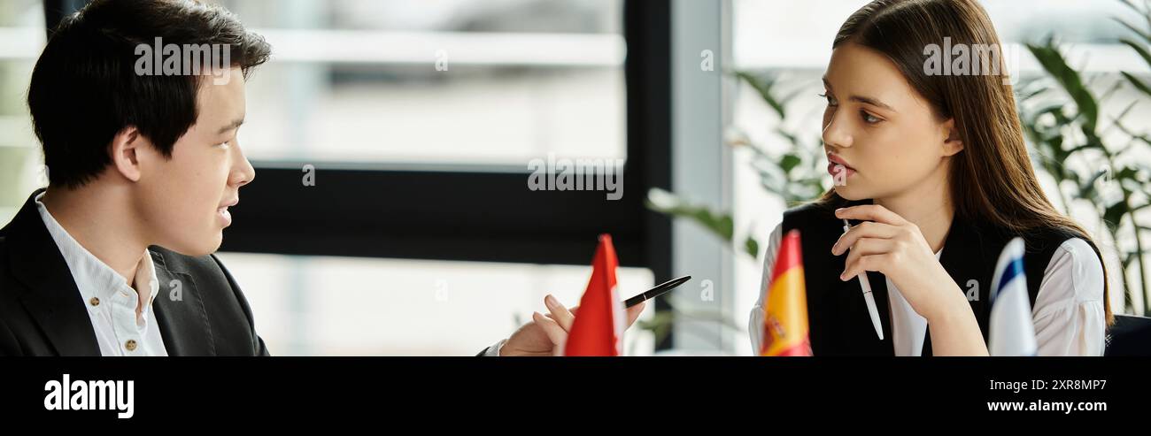 Two teenagers engage in a serious discussion during a Model United ...