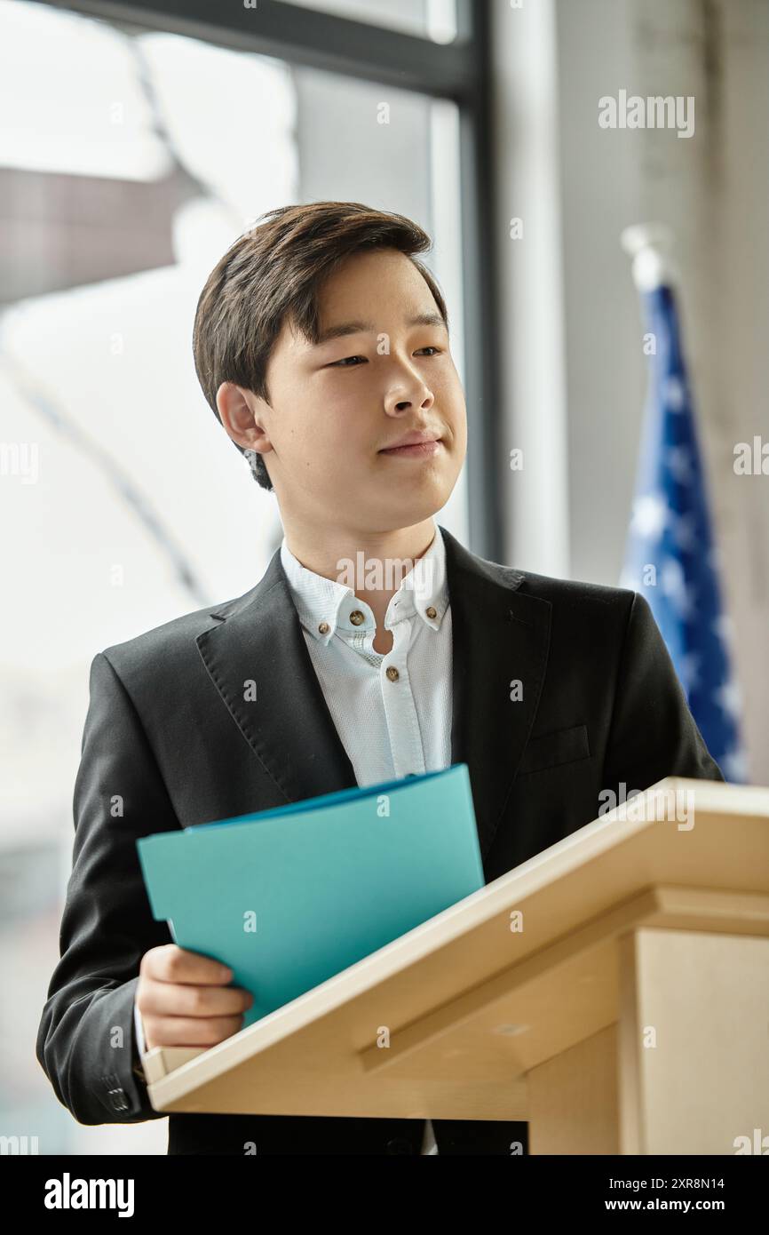 Teenage boy in a suit stands at a podium, ready to address a UN Model ...