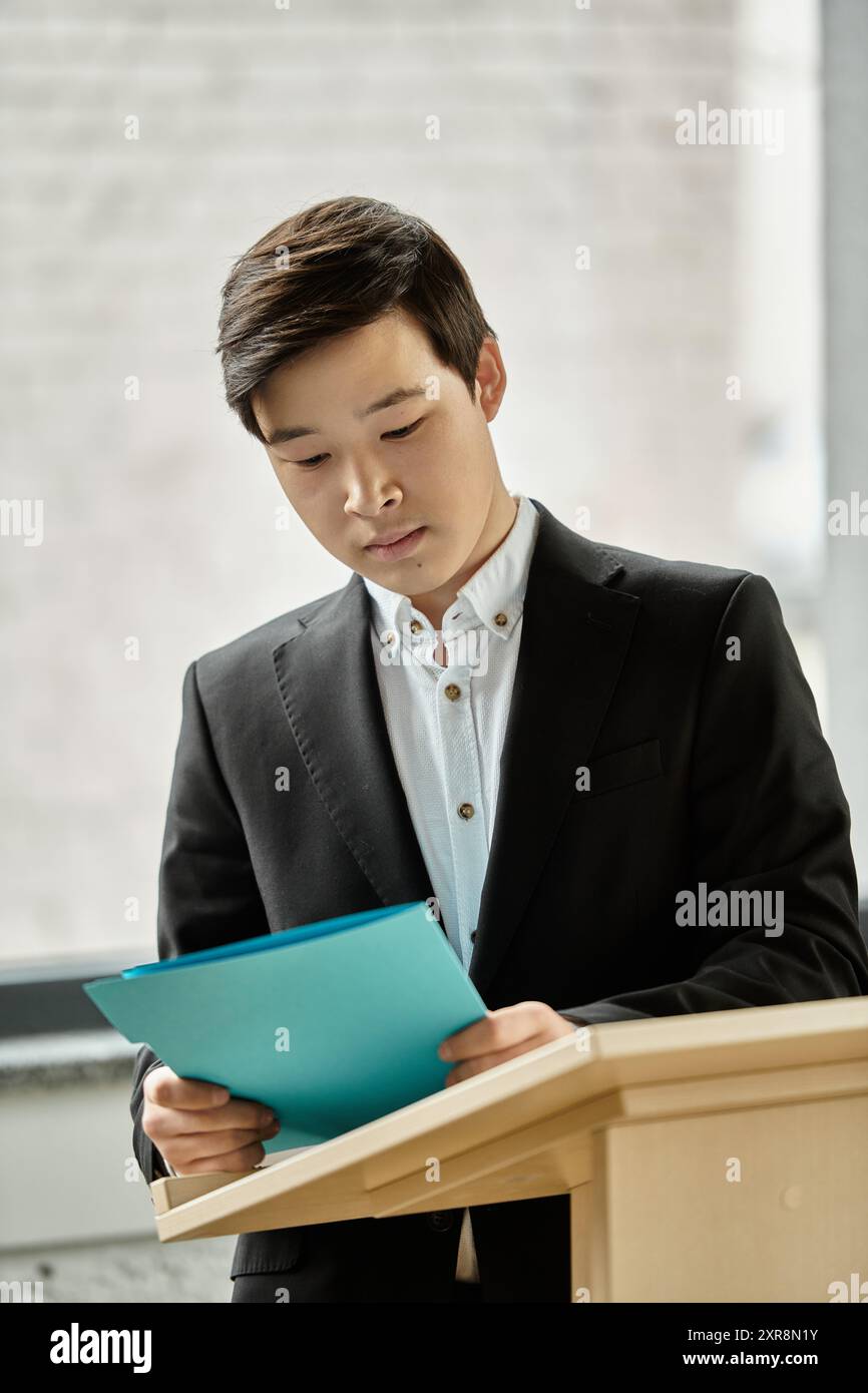 A young delegate prepares to deliver a speech at a UN Model conference ...
