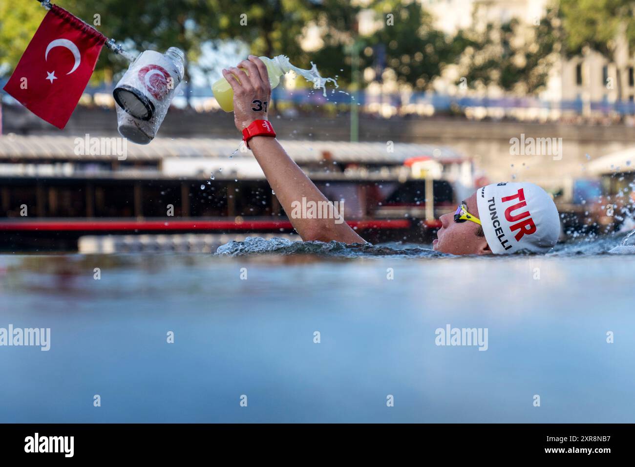 Turkey's Kuzey Tuncelli grabs a sports drink in the feeding station ...