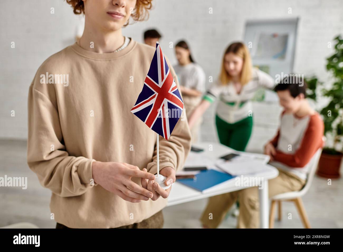A young delegate holds a British flag during a Model United Nations ...