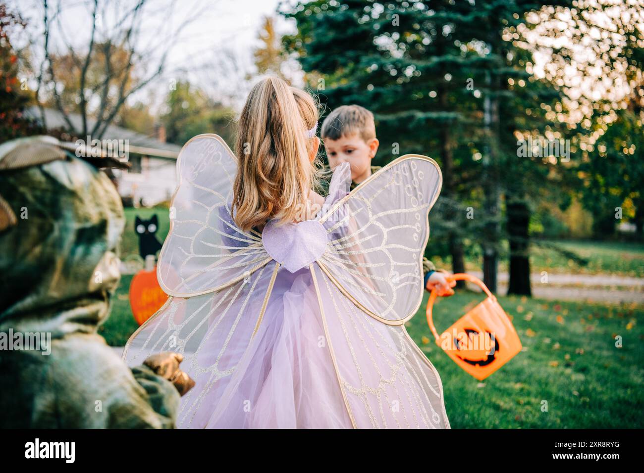 Child in fairy costume outdoors during Halloween playtime Stock Photo ...