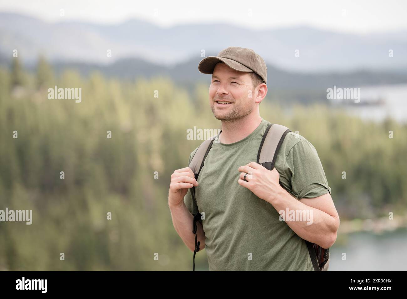 White male hiker smiling with beautiful scenery behind Stock Photo - Alamy