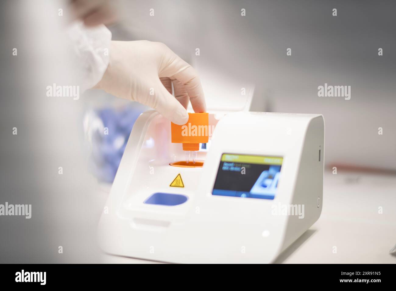 Lab technician placing cartridge into point-of-care testing mach Stock ...