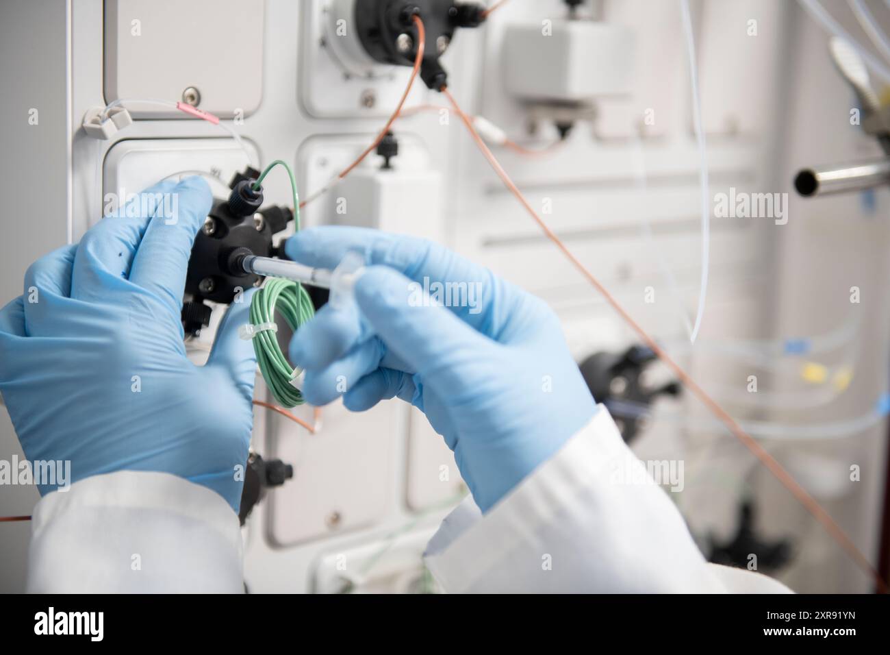 Scientist making adjustments to a machine in a biotech lab Stock Photo ...