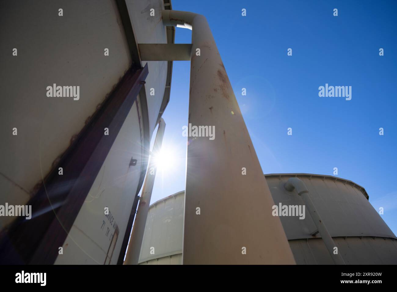 Pipe extending from a large scale water storage tank with sun fl Stock ...
